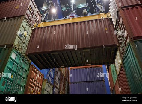 Operation Of Container Terminal At Night Unloading Container Ship At Night Mooring Cranes