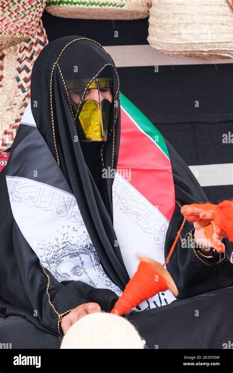 Masked Arab Woman From Abu Dhabi Wearing An Abaya At A Folklife