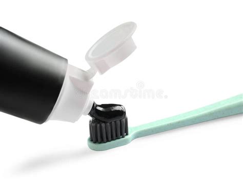Tube Of Charcoal Toothpaste And Brush On White Background Stock Photo