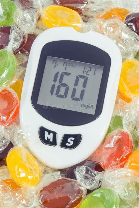 Glucose Meter With High Sugar Level And Candies Healthy Lifestyle Nutrition And Reduction