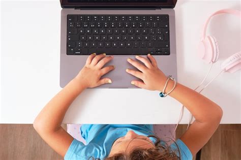 Premium Photo Picture From Above Of Curlyhaired Brunette Girl With Hands On Laptop On Top Of