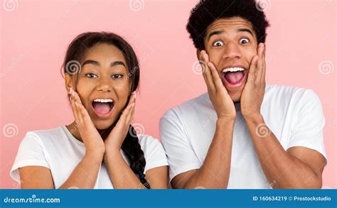 Guy And Girl Screaming In Surprise And Touching Cheeks Stock Image