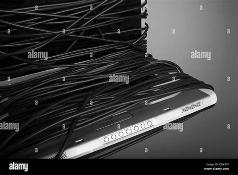 Laptop Covered In Power Cable Stock Photo Alamy