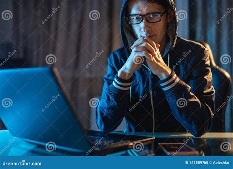 Male In The Hood Looking In The Camera Hacker Attacks And Stealing