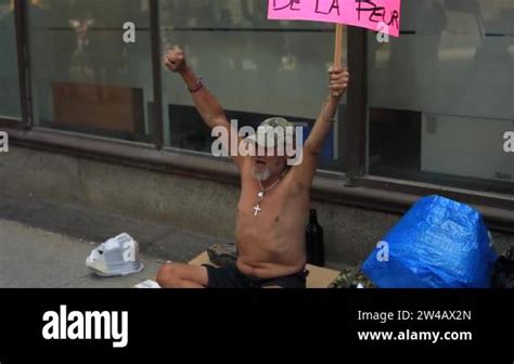 Shirtless Man Sitting On Pavement With Poster Stock Video Footage Alamy