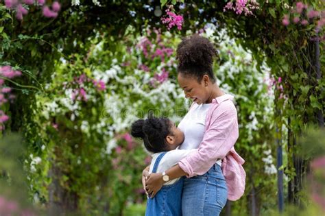African Mother And Her Daughter Hugging Each Other While Happily