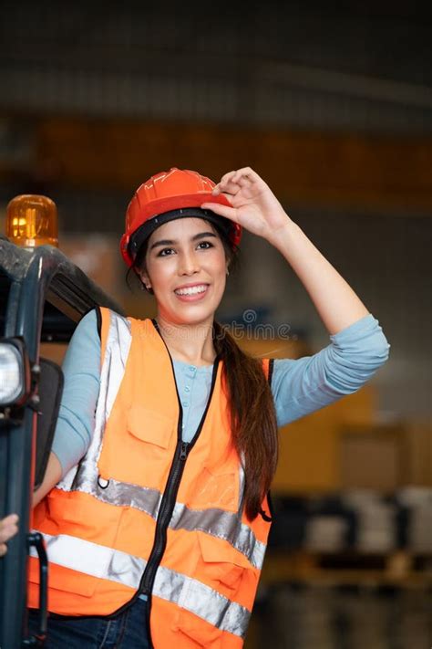 Portrait Of An Asian Woman With A Forklift Used To Lift Heavy Objects