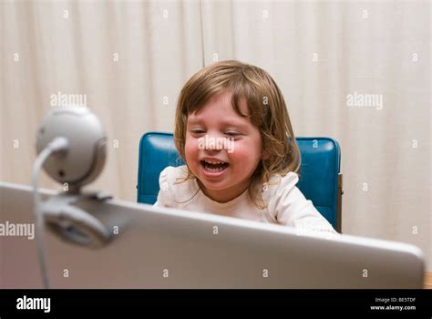 Young Girl Three Years Old Laughing During A Webcam Chat With Her