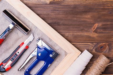 Premium Photo A Tool For Stretching A Canvas With A Photo On A Wooden