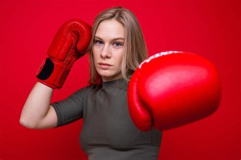 Premium Photo Sporty Young Woman In Red Boxing Gloves Practicing Punches