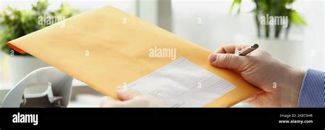 Man Holding Yellow Envelope And Going To Fill In Personal Address On