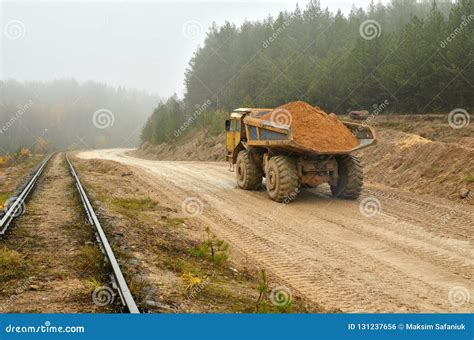 Earth Mover Loading Dumper Truck With Sand In Quarry Excavator Loading