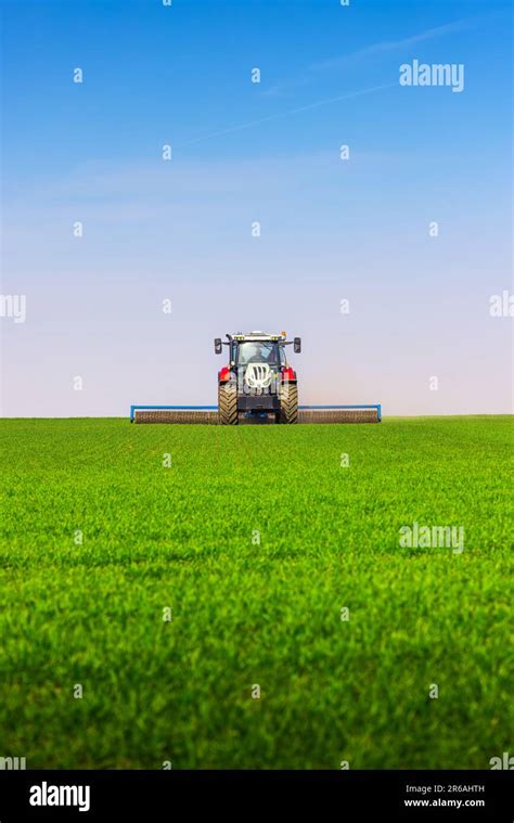 Tractor With A Roller Tillage On Spring Field Soil Rolling Supports