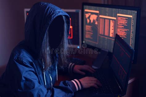 Anonymous Hacker Programmer Uses A Laptop To Hack The System In The Dark Concept Of Cybercrime