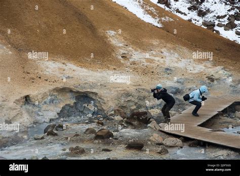 People Taking Photos At Gunnuhver Geothermal Field In Iceland Stock