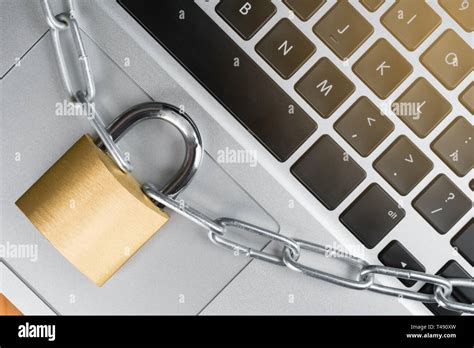 Padlock With Chain On A Laptop Computer Keyboard Cyber Security Abstract Concept Stock Photo