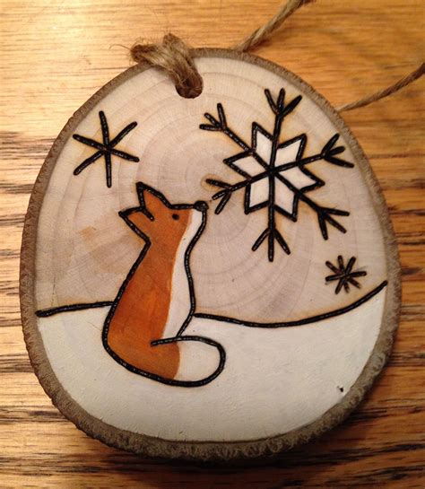 A Wooden Plaque With A Fox And Snowflakes On Its Side In The Shape Of