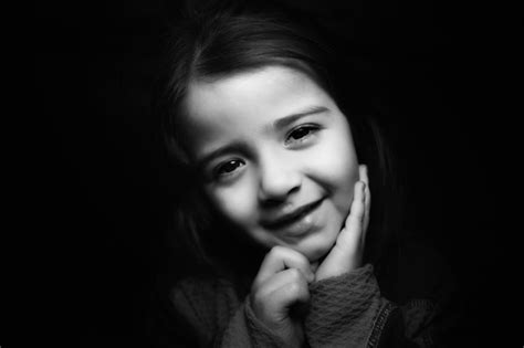 Premium Photo Portrait Of Cute Girl Smiling Against Black Background