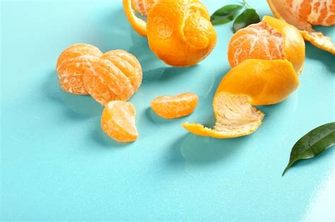 Premium Photo Tasty Peeled Tangerines On Color Background