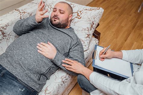 우울한 남자는 심리학자를 방문 한다 심리학자 쓰기 노트와 그의 환자를 안심 It 지원에 대한 스톡 사진 및 기타 이미지 It