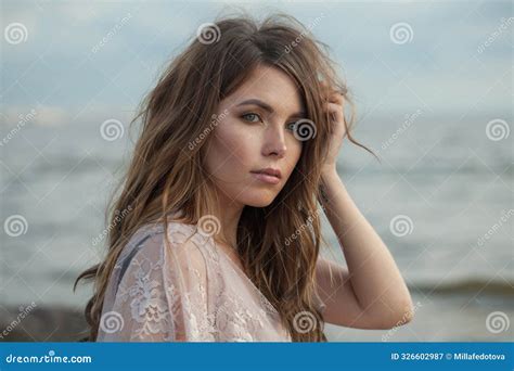 Healthy Young Adult Female Model With Windy Brown Hair Walking Outdoor