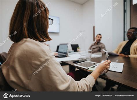 Multicultural Colleagues Analyzing Statistics Strategizing Business Growth Profitability