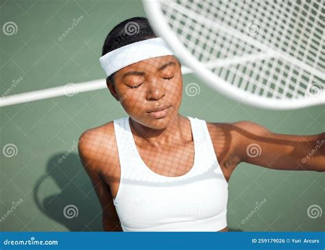 She Glows Differently A Sporty Young Woman Shielding Her Face From The