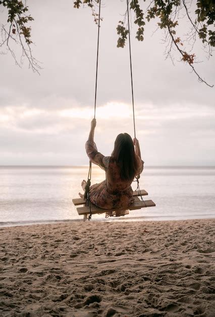 Premium Photo Woman On The Swings On The Sea Beach Concept Of The