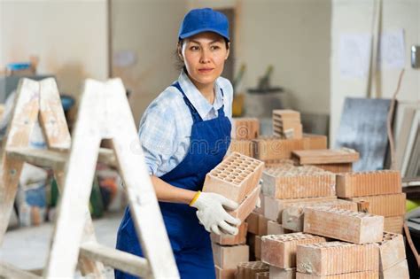 Female Builder Is Laying Bricks On Top Of Each Other Stock Image Image Of Engineer Woman