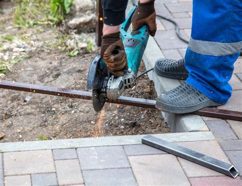 A Worker Cuts Metal At A Construction Site Stock Image Image Of
