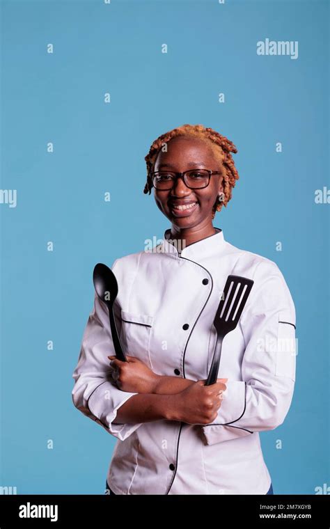 African American Female Head Chef Of Restaurant Holding Cooking