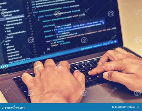 Close Up Of A Programmer`s Hands Writing Source Codes Stock Image