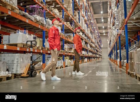 Experienced Warehouse Staff Conducting A Racking System Inspection