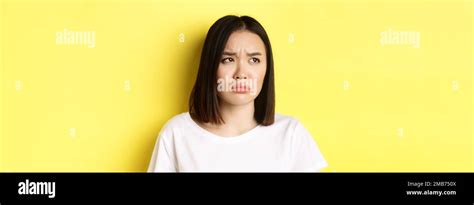 Sad And Jealous Asian Girl Sulking Frowning And Looking Left With