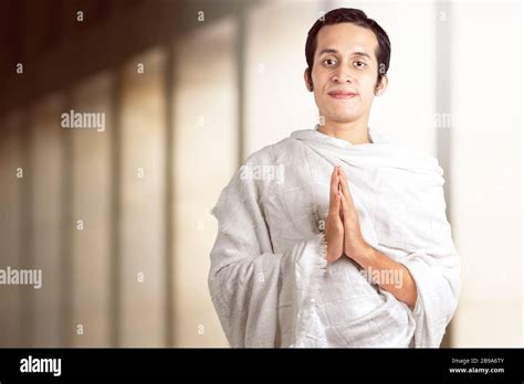Asian Muslim Man In Ihram Clothes Standing And Praying Inside The