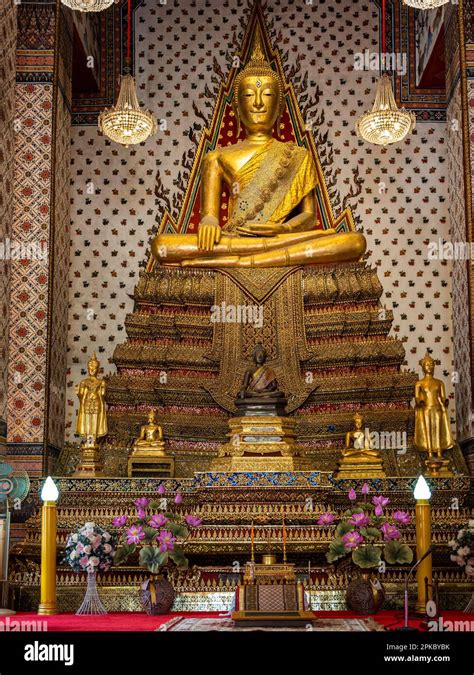 A Stunning Golden Buddha Statue Seated On A Throne Adorned With