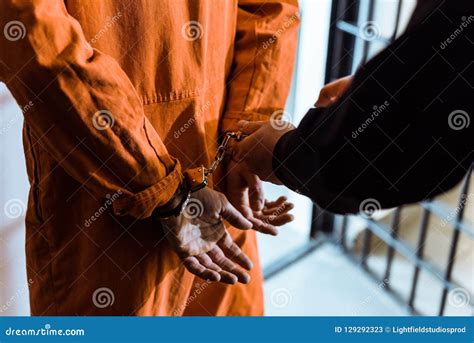 Cropped Image Of Prison Officer Wearing Handcuffs Stock Image Image