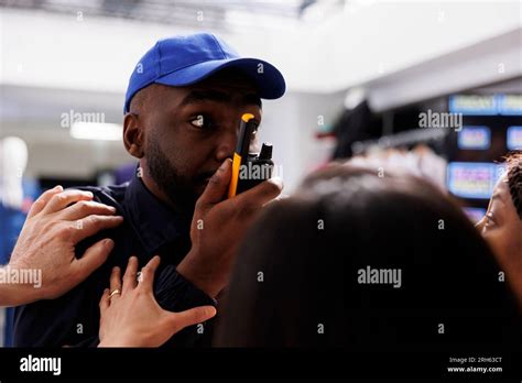 Rude Aggressive Shoppers Push Security Guard Talking By Walkie Talkie