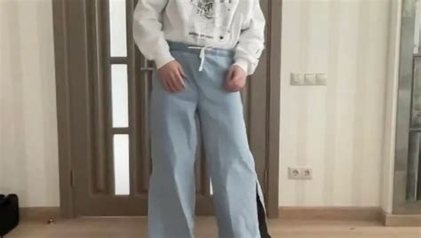 Crossdresser In A White Blouse And Blue Wide Leg Jeans Masturbating And