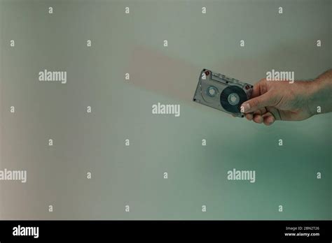 Hand Holding Audio Cassette Tape In The Color Light Beautiful Minimal