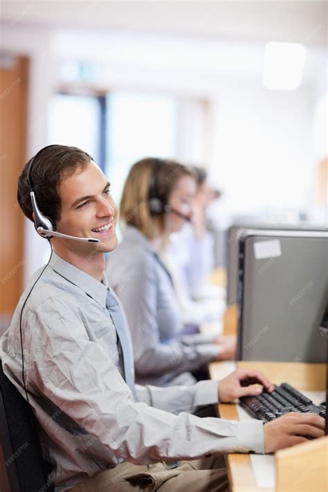 Premium Photo Portrait Of A Smiling Customer Assistant Using A Headset