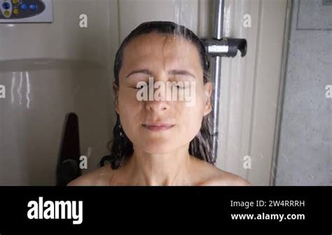 Young Woman Takes A Shower While Standing Under Stream Of Water Girl