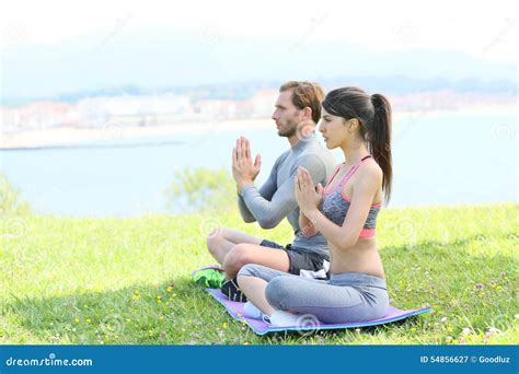 Couple Doing Yoga Meditation By The Seaside Stock Image Image Of