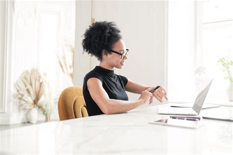 Premium Photo Freelancer A Woman With Glasses Works With Documents
