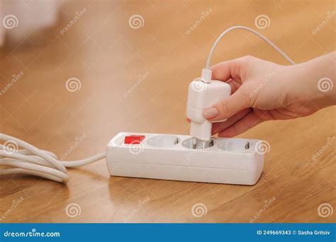 Woman Pluging The Wire Into White Extension Cord Close Up Of Female Hand Put Cabel Stock Image