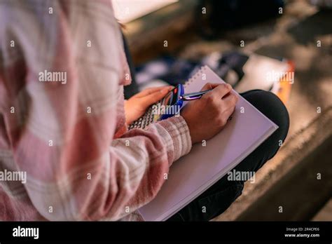 school girl writing homework she is calculating mathematics task