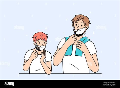 Happy Caring Young Father Teach Teenage Son Shaving Beard In Home