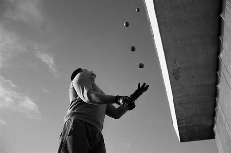 Premium Photo Low Angle View Of Man Playing With Balls