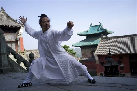 Master Chen Shiyu Is Performing A Form In Front Of An Ancient Temple On