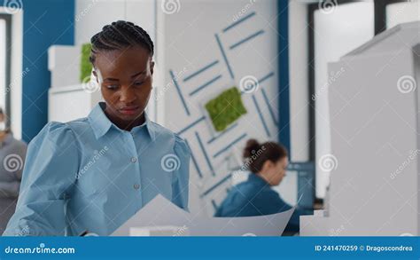 Portrait Of Woman Architect Analyzing Blueprints Plans To Design Construction Layout And